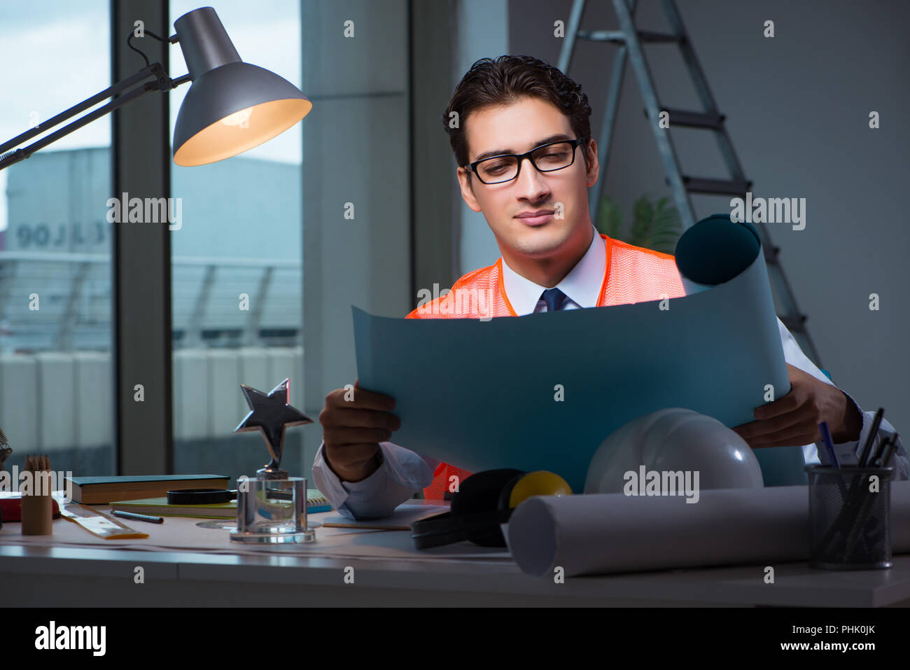 Construction architect working on drawings late at night Stock Photo ...