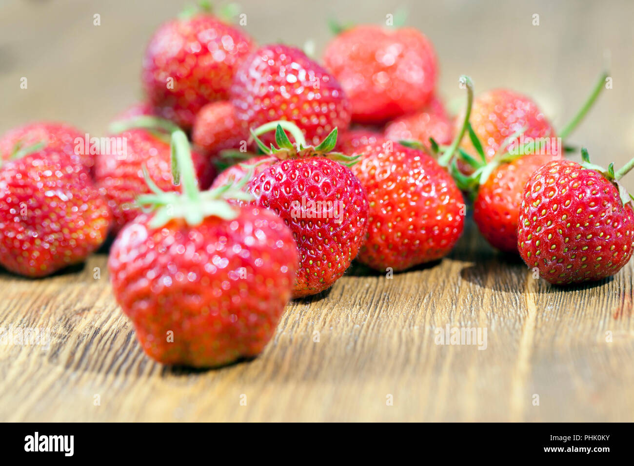 red berries of a large strawberry grown in a private area near the ...