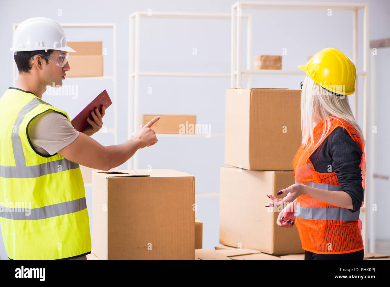 Delivery contractor delivering boxes to office Stock Photo - Alamy