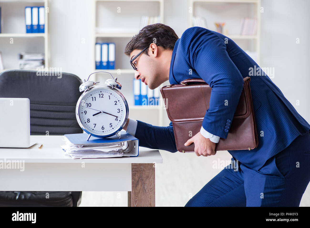 Businessman in bad time management concept Stock Photo - Alamy