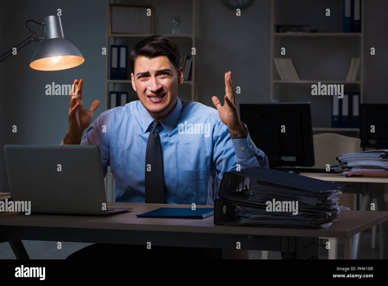 Employee working late at night at important report Stock Photo - Alamy