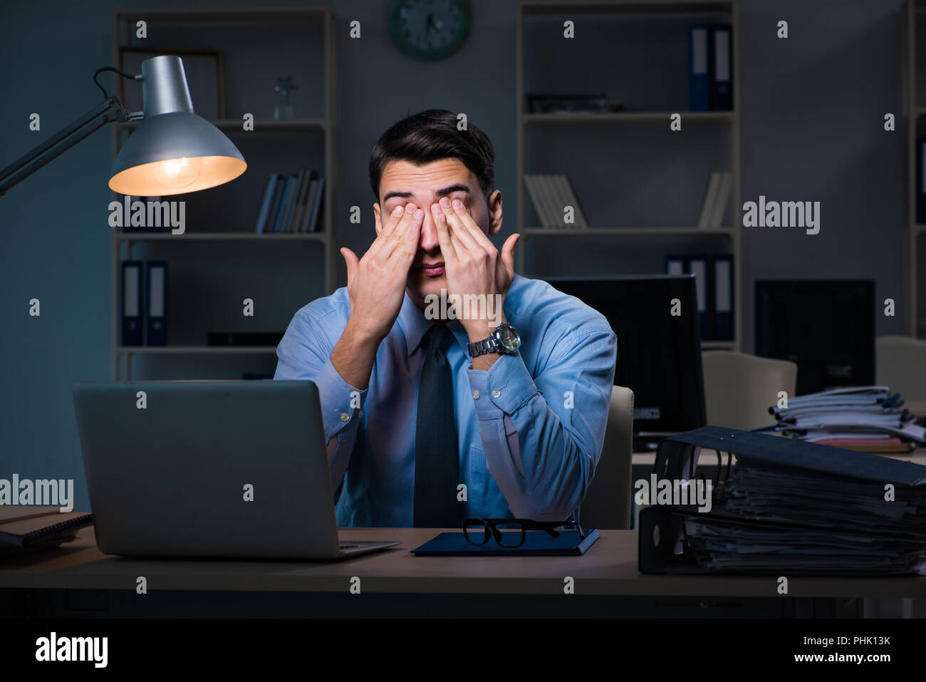 Employee working late at night at important report Stock Photo - Alamy