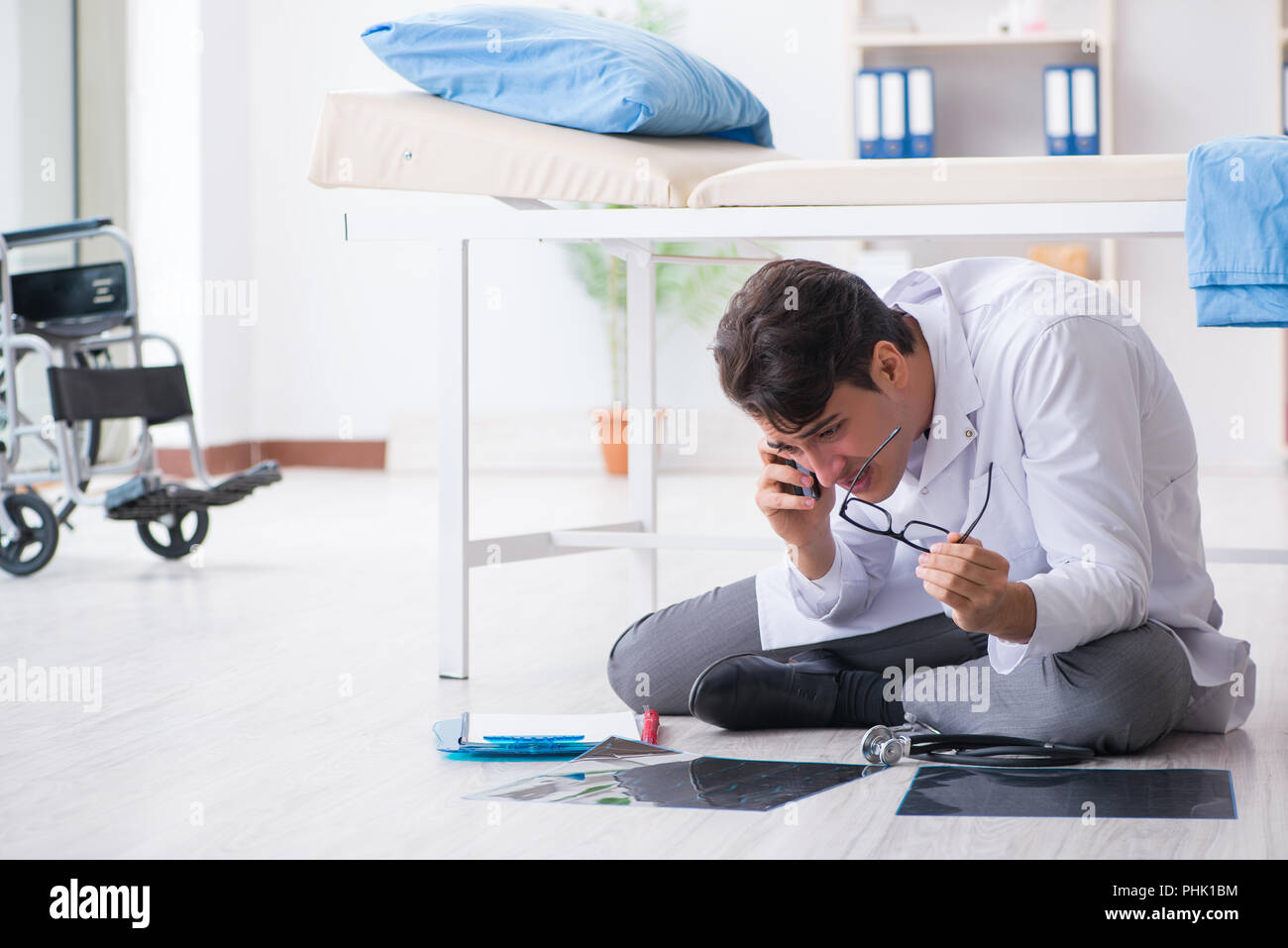 Doctor sitting on the floor in hospital Stock Photo - Alamy