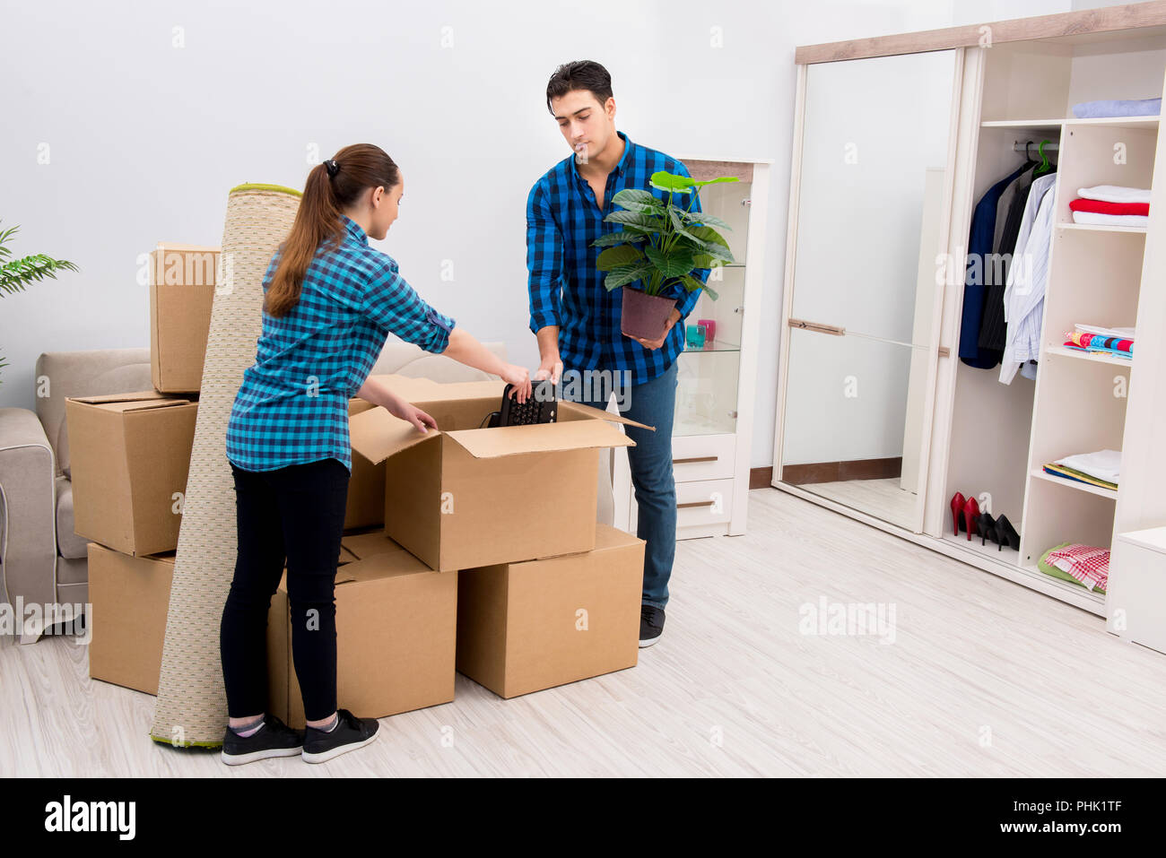 Young family relocating to new house apartment Stock Photo - Alamy