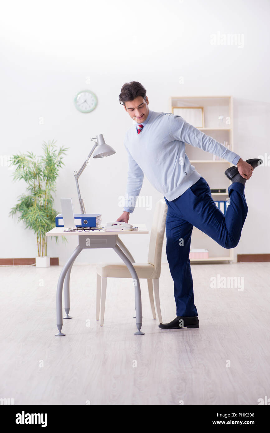 Employee doing stretching exercises in the office Stock Photo - Alamy