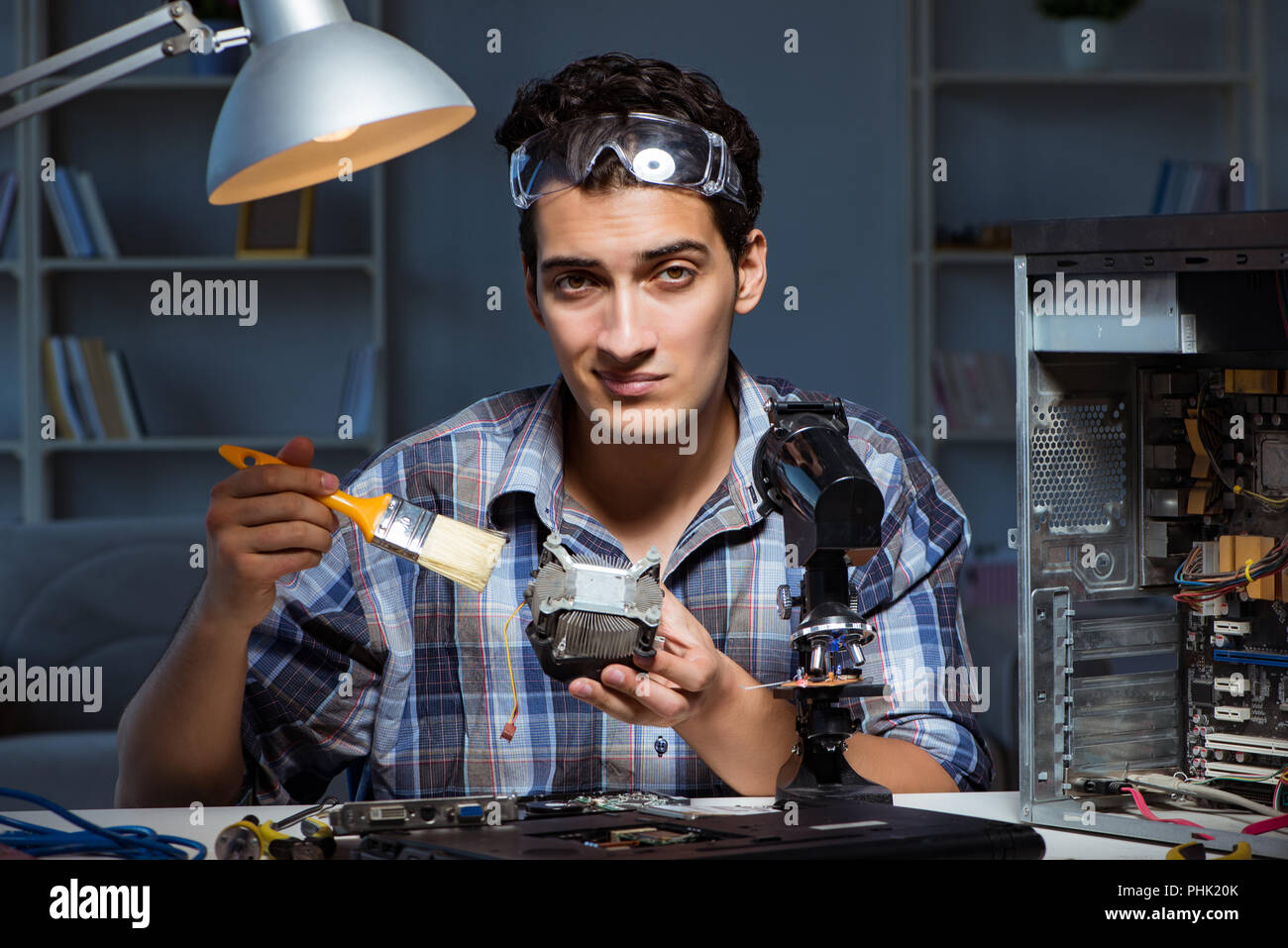 Computer repair man cleaning dust with brush Stock Photo - Alamy