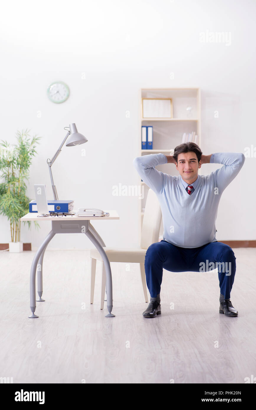 Employee doing stretching exercises in the office Stock Photo - Alamy