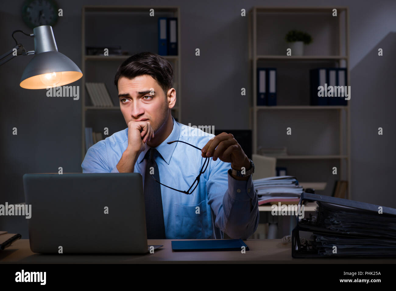 Employee working late at night at important report Stock Photo - Alamy