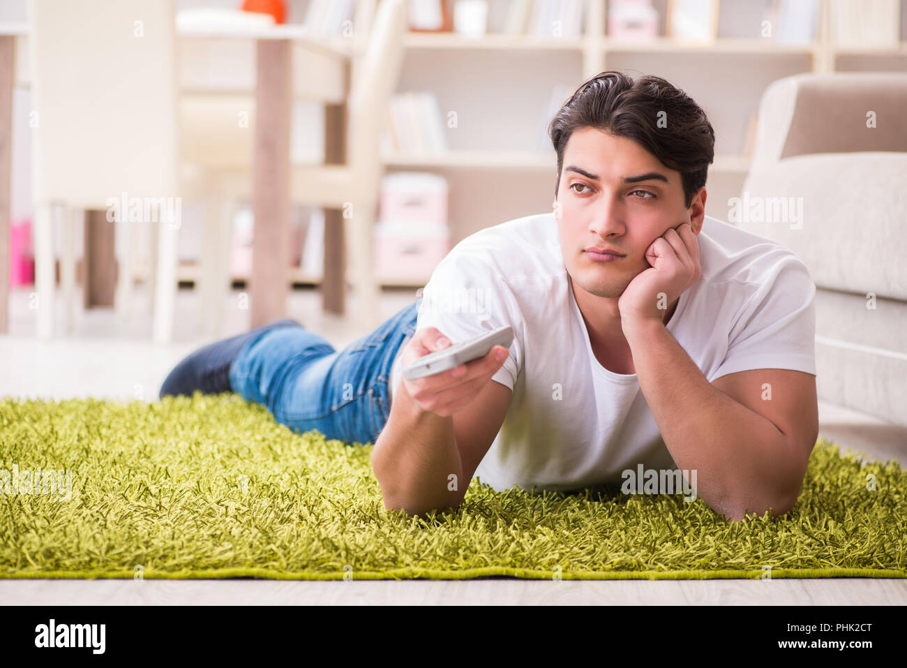 Man watching tv at home on floor Stock Photo - Alamy