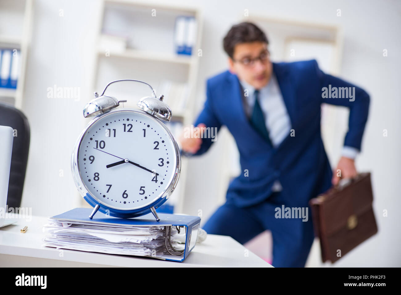 Businessman in bad time management concept Stock Photo - Alamy