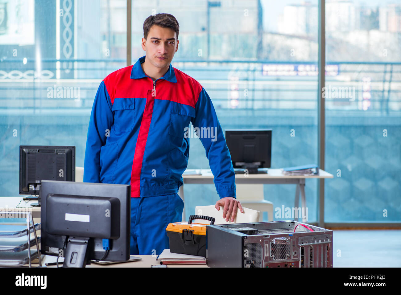 Computer technician repairing broken computer in workshop Stock Photo ...