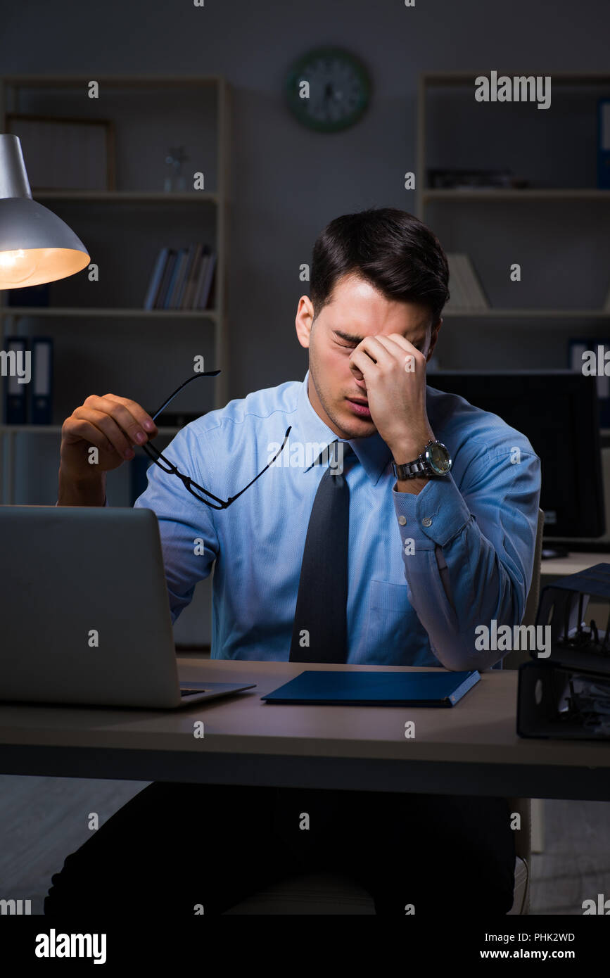 Employee working late at night at important report Stock Photo - Alamy