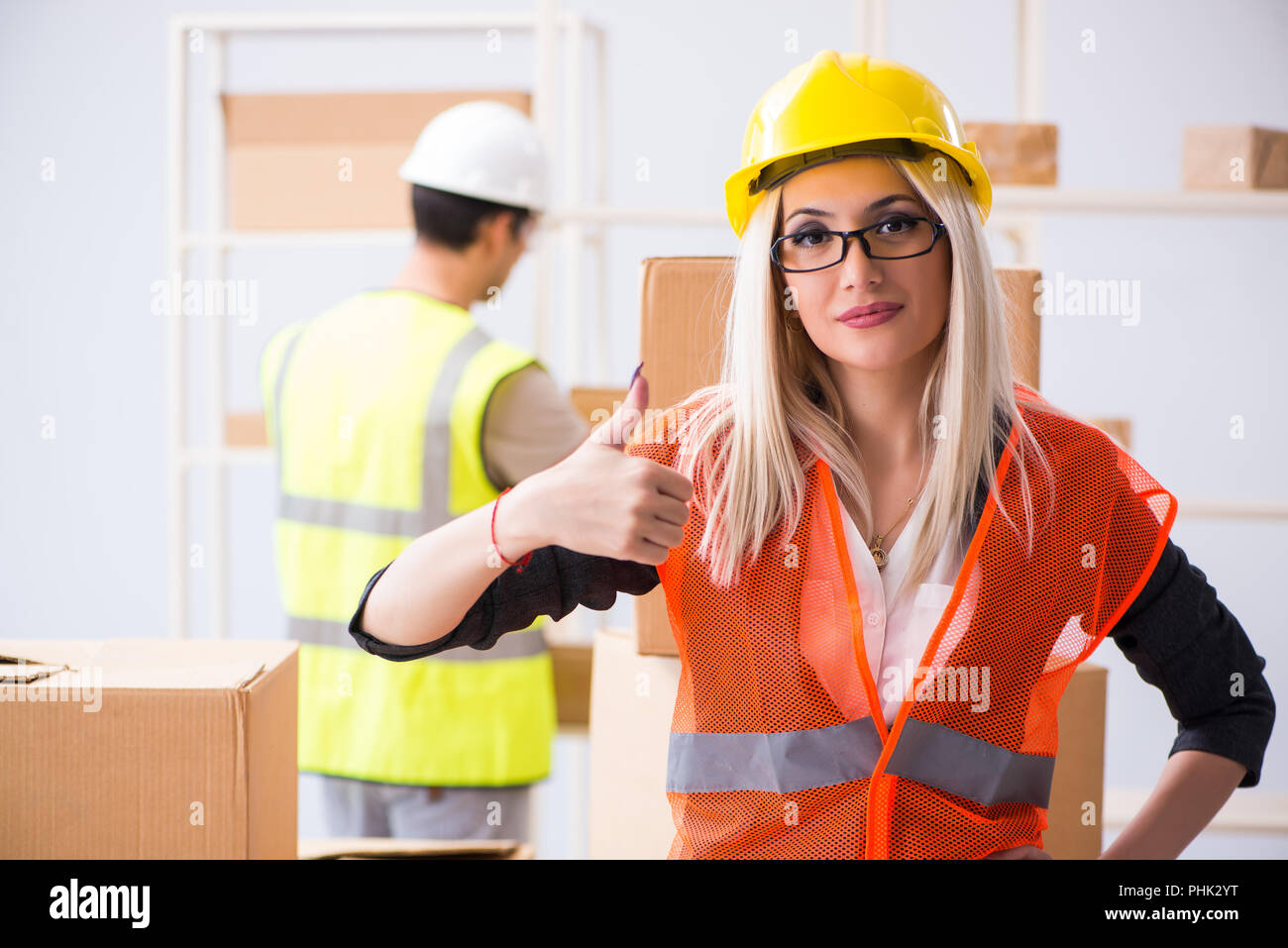 Delivery contractor delivering boxes to office Stock Photo - Alamy