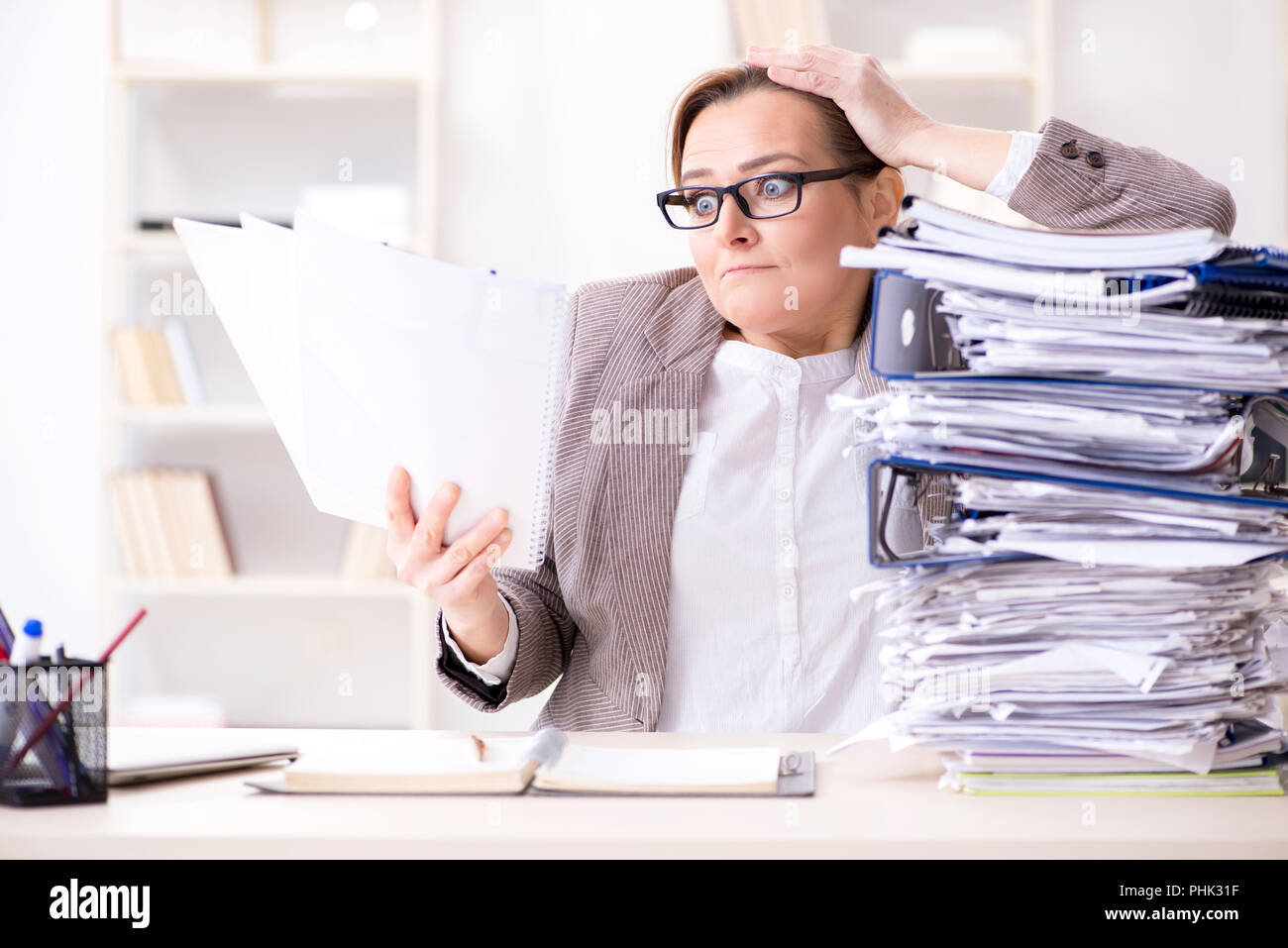 Businesswoman very busy with ongoing paperwork Stock Photo - Alamy