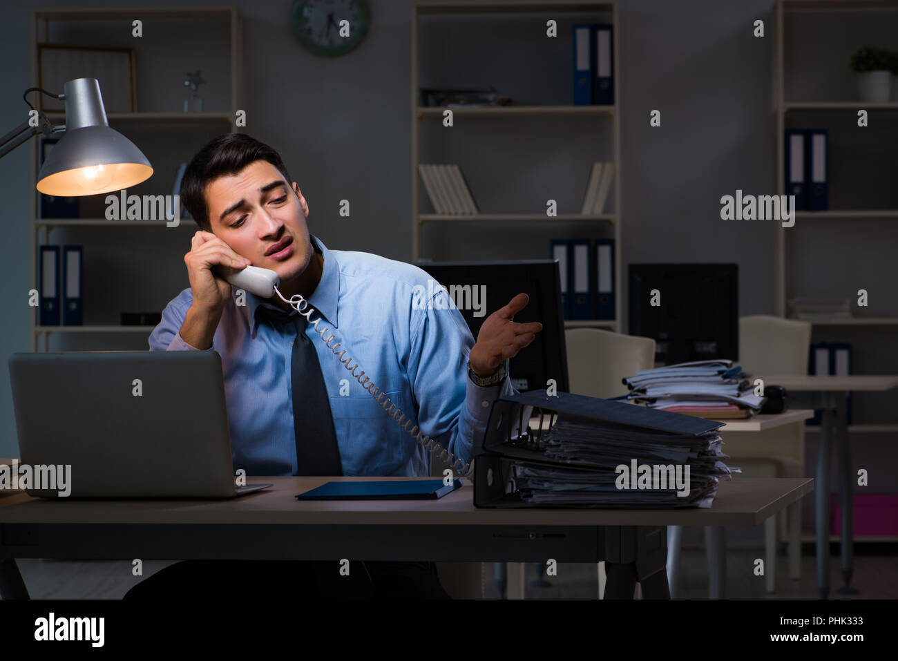 Employee working late at night at important report Stock Photo - Alamy