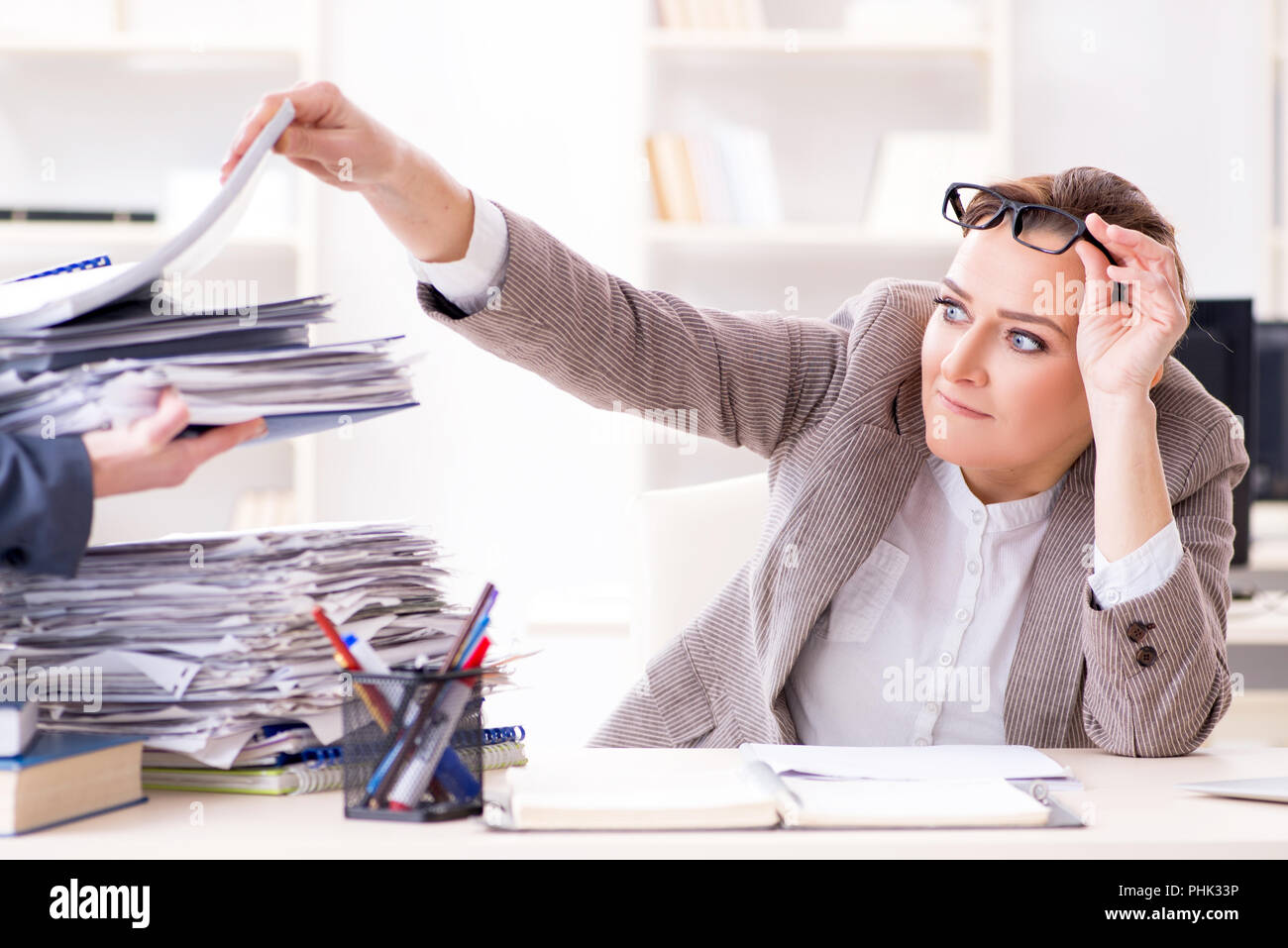 Businesswoman very busy with ongoing paperwork Stock Photo - Alamy