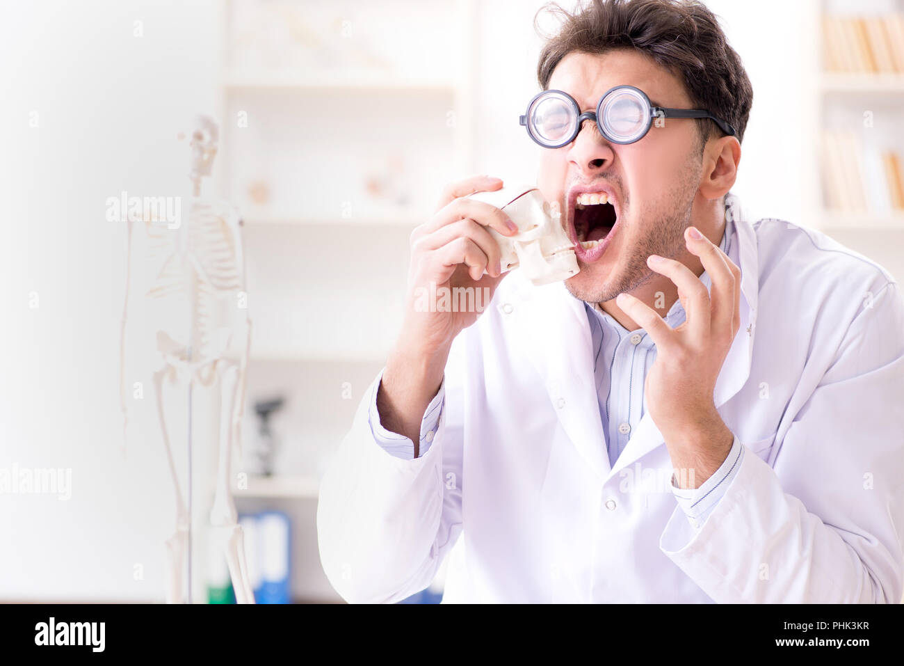 Crazy doctor studying human skeleton Stock Photo - Alamy