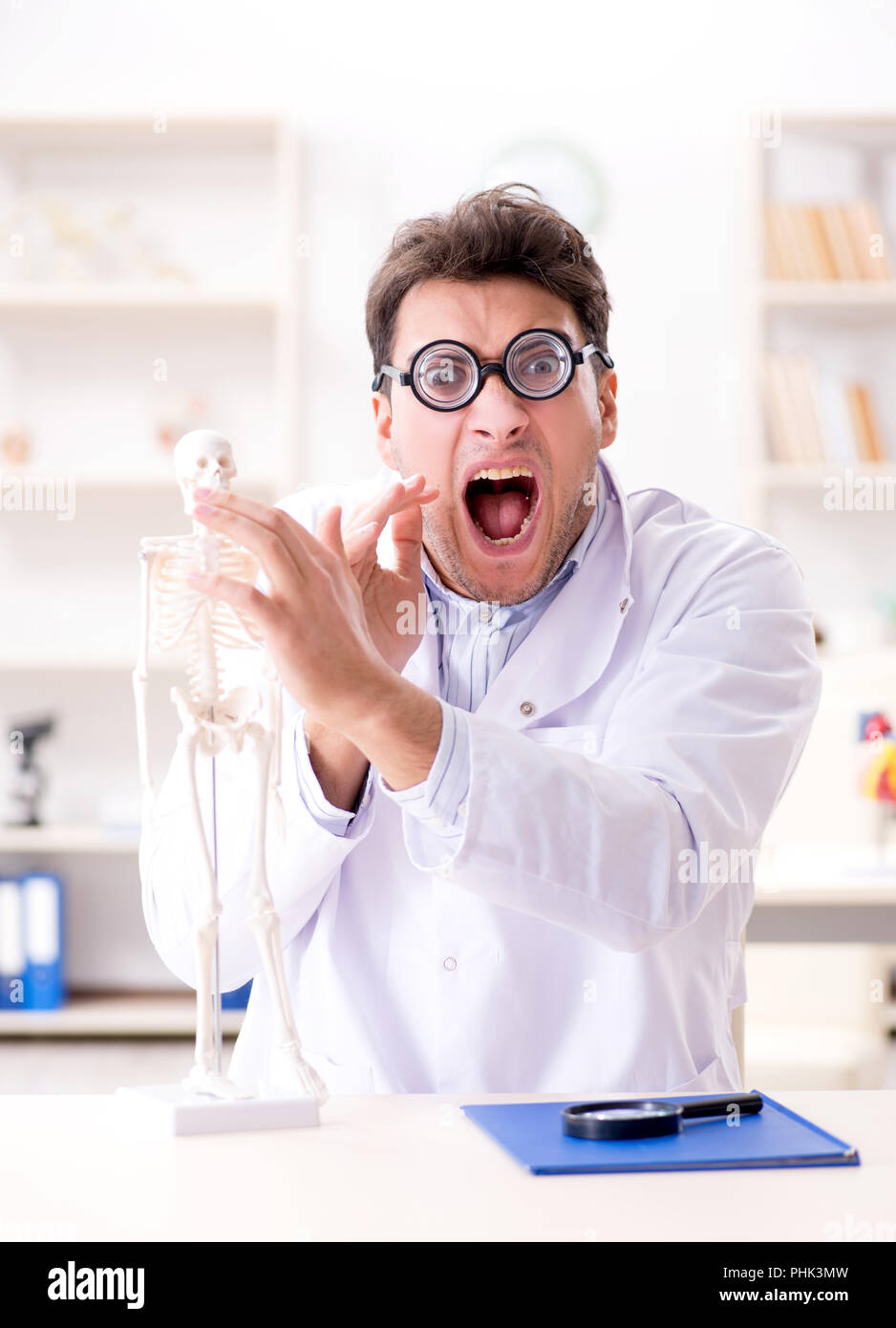 Crazy doctor studying human skeleton Stock Photo - Alamy