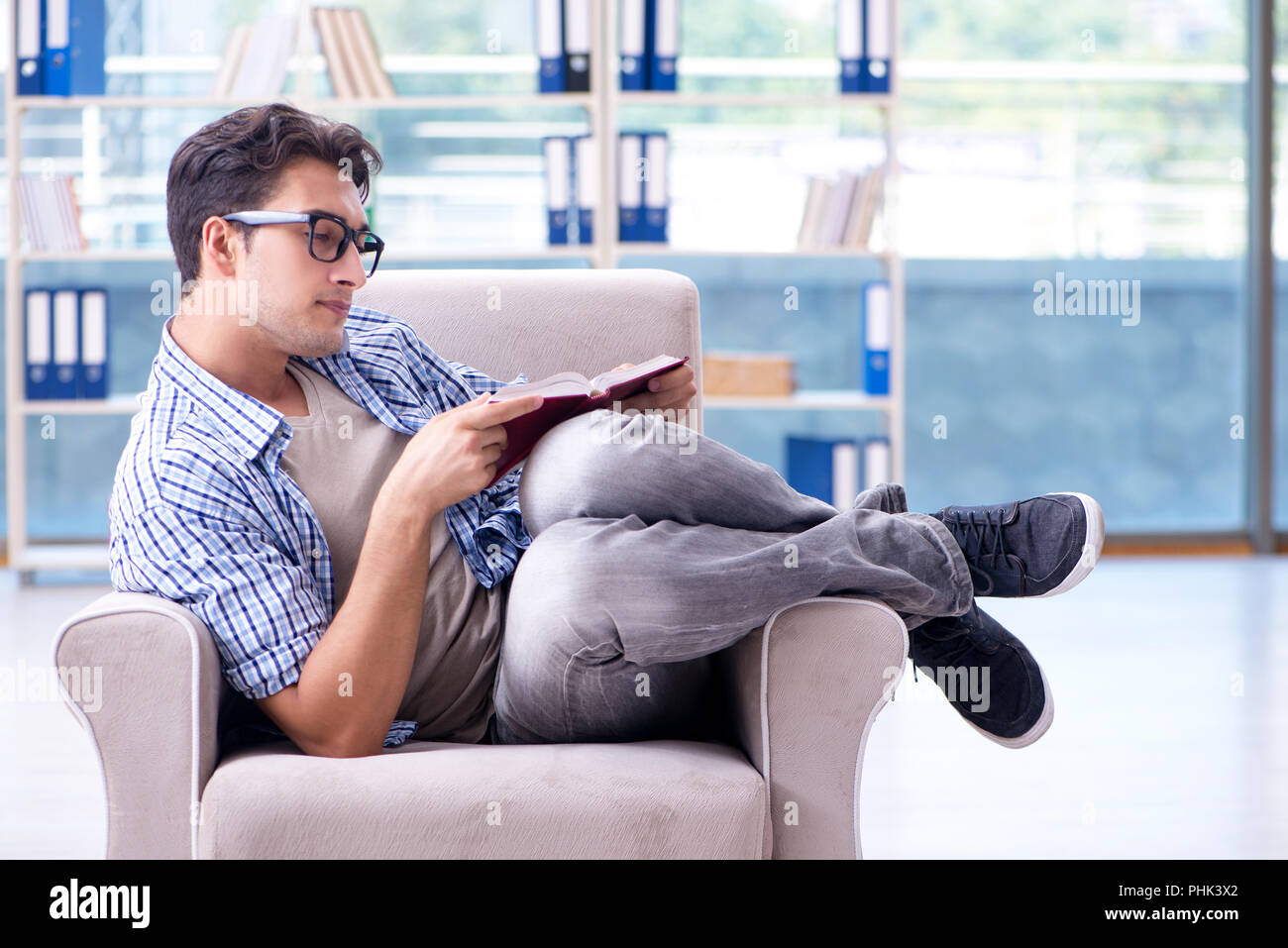 Student reading books and preparing for exams in library Stock Photo ...