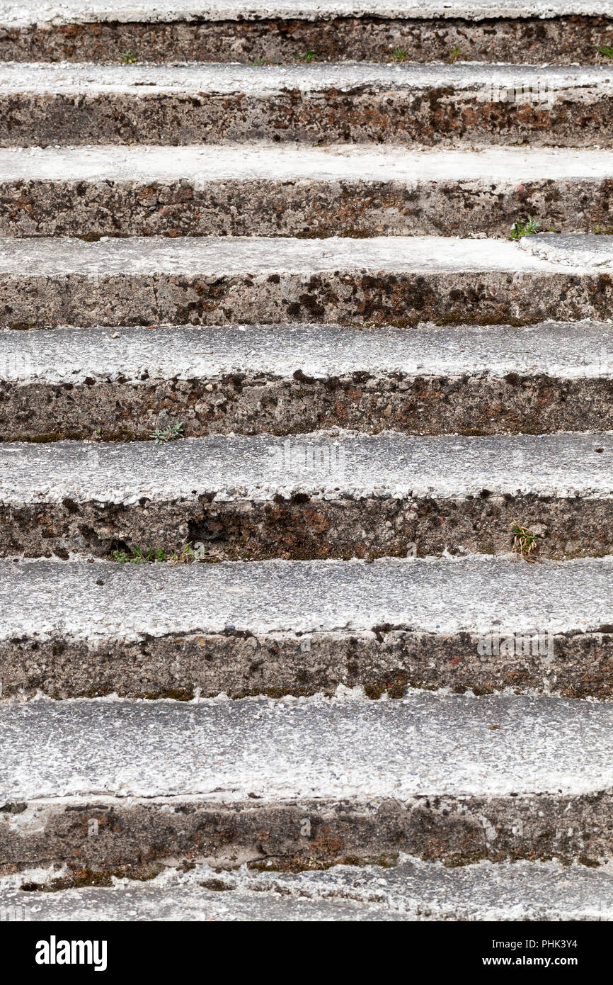 crumbling old concrete staircase made of cement, closeup in an old park ...