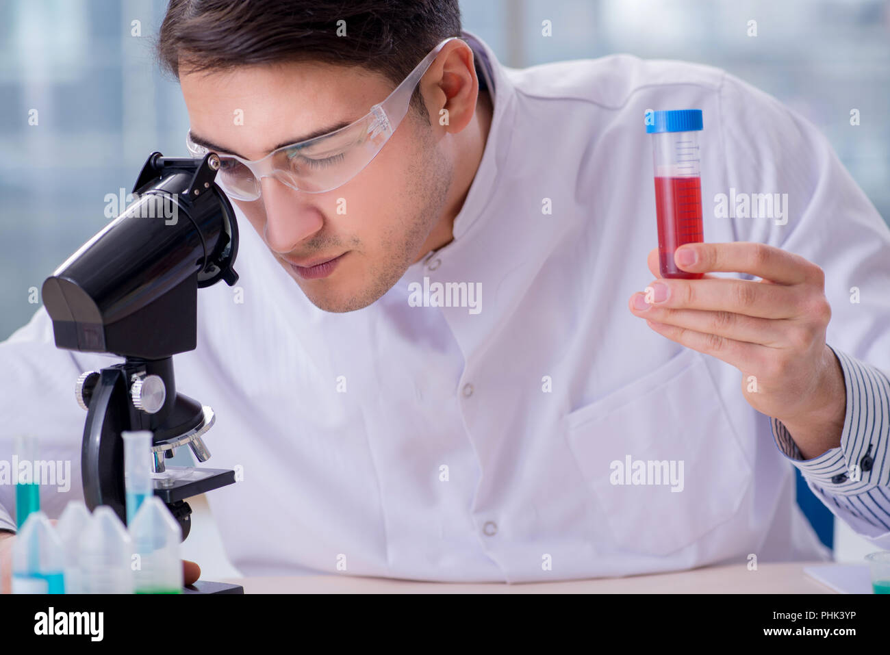 Man doctor checking blood samples in lab Stock Photo - Alamy