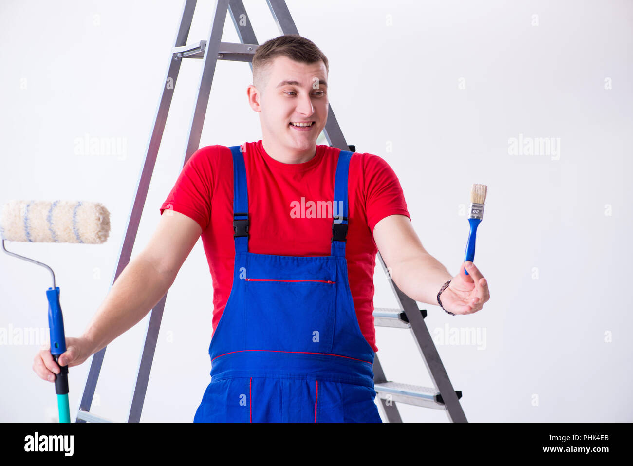Male painter preparing for painting job at construction site Stock ...