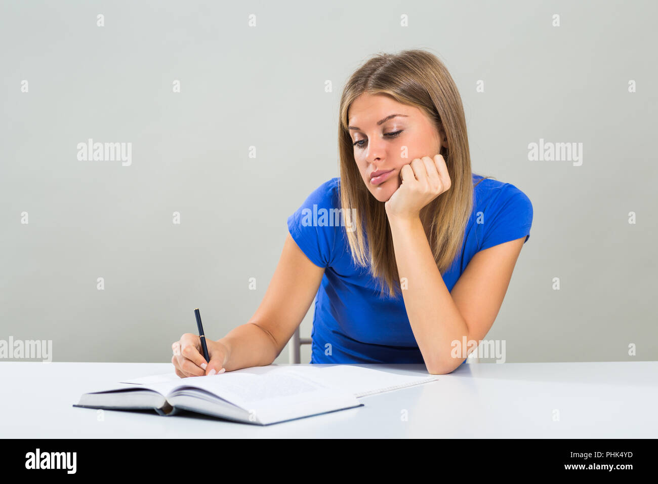 Sad female student doesn't want to study Stock Photo - Alamy