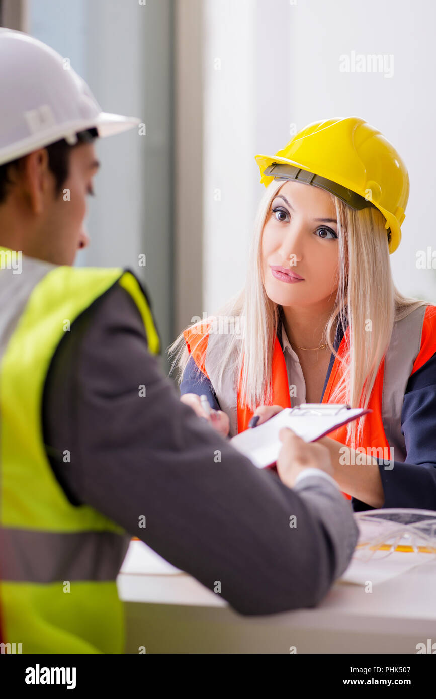 Construction workers having discussion in office before starting Stock ...
