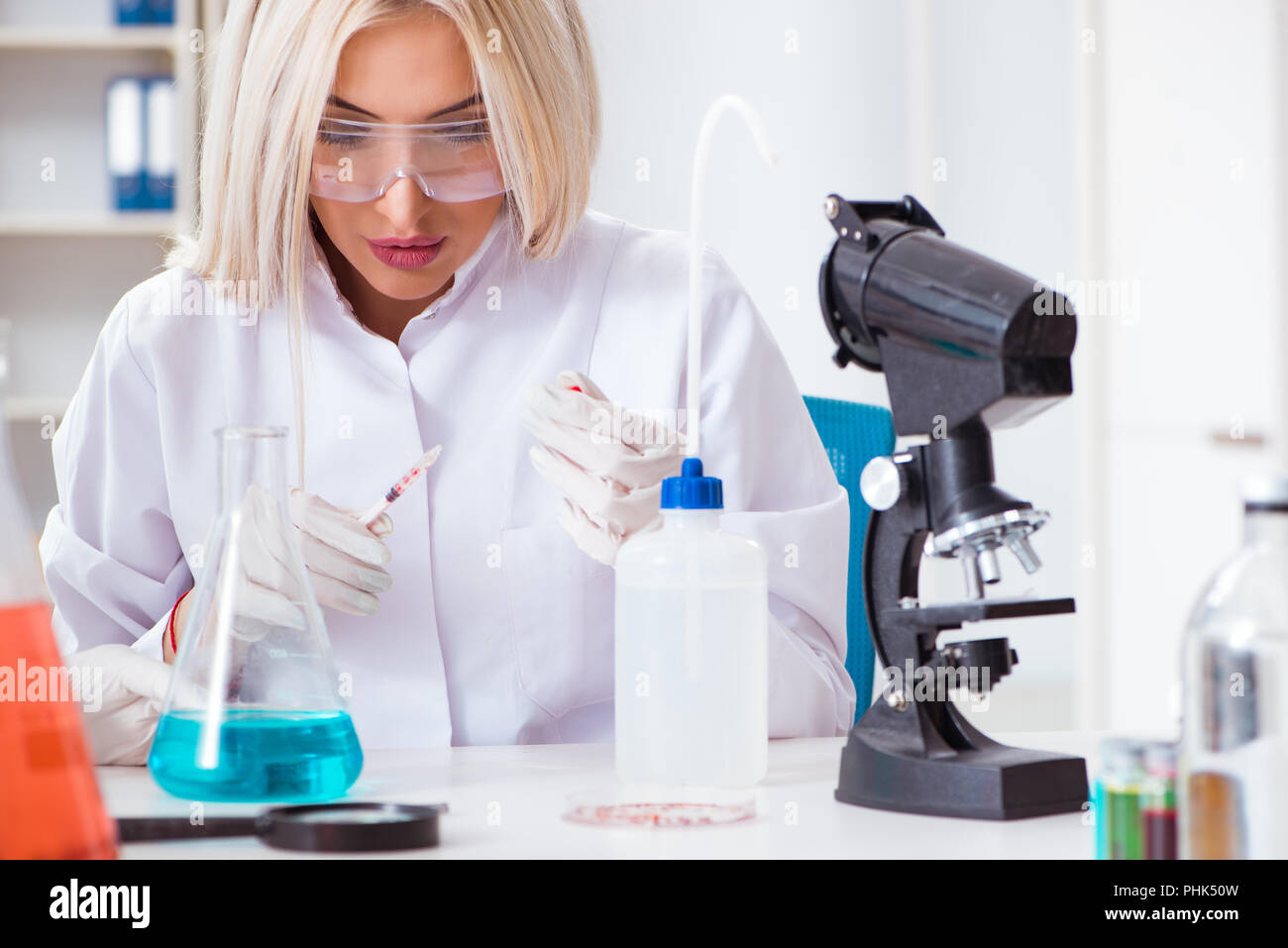 Woman lab analyst working on new drugs Stock Photo - Alamy