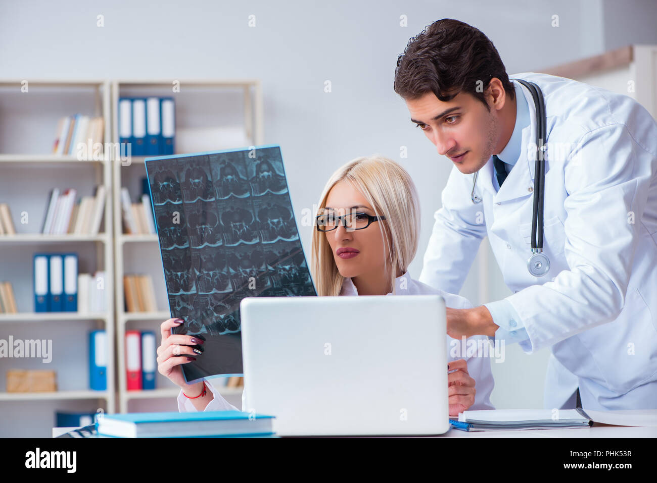 Two doctors examining x-ray images of patient for diagnosis Stock Photo ...