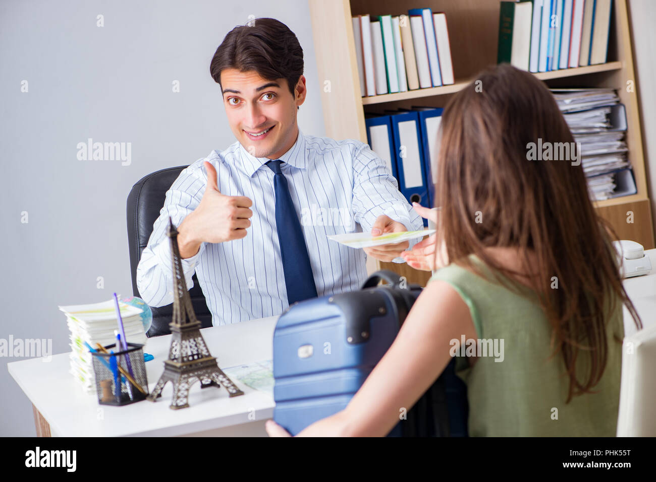 Customer visiting travel agency and talking to agent Stock Photo - Alamy