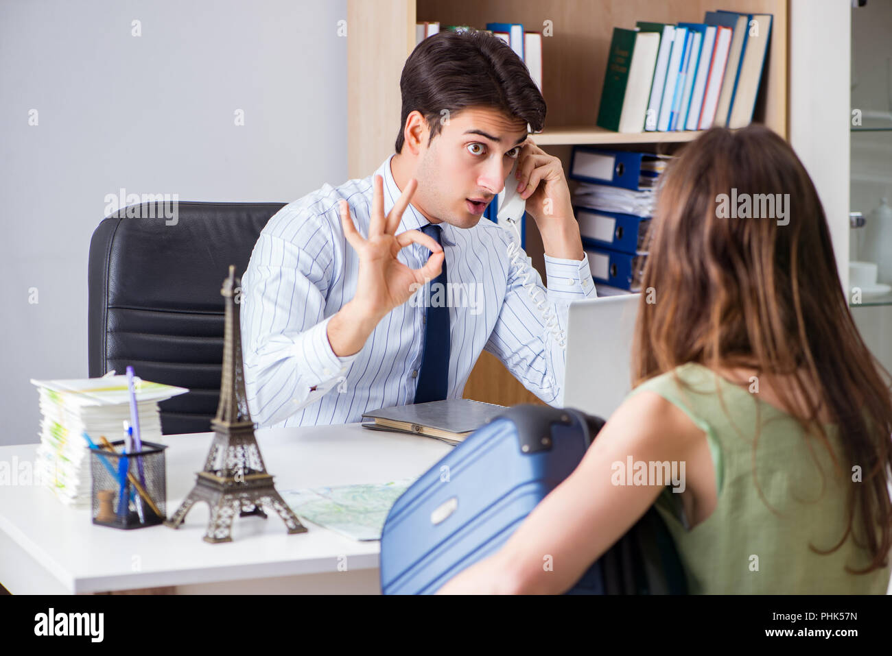 Customer visiting travel agency and talking to agent Stock Photo - Alamy
