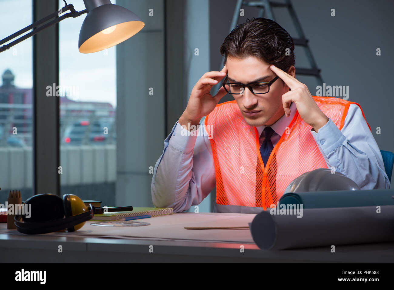 Construction architect working on drawings late at night Stock Photo ...