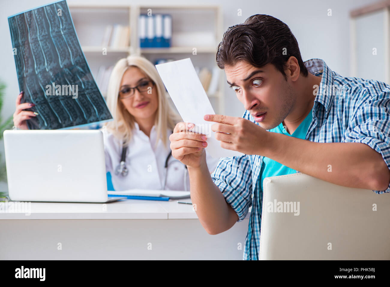 Male patient angry at expensive healthcare bill Stock Photo - Alamy