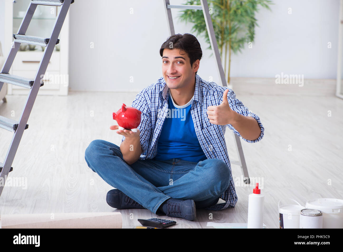 Young man overspending his budget in refurbishment project Stock Photo ...