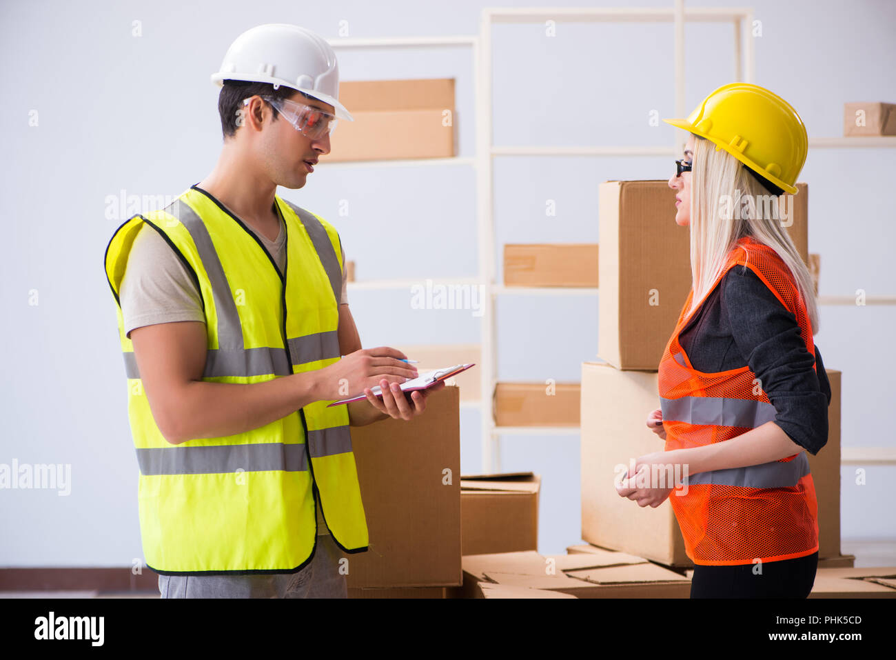 Delivery contractor delivering boxes to office Stock Photo - Alamy