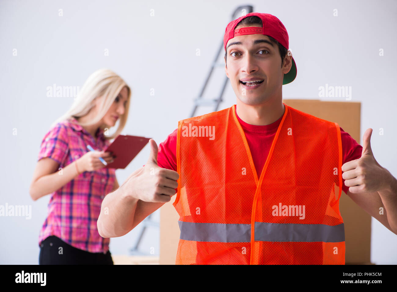 Thumb up young courier delivering hi-res stock photography and images ...