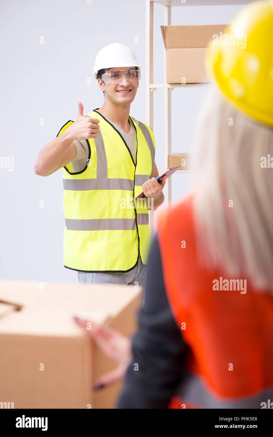 Delivery contractor delivering boxes to office Stock Photo - Alamy