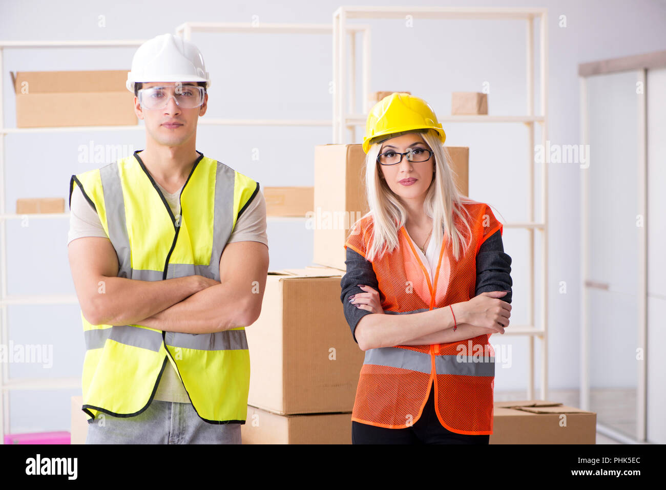 Delivery contractor delivering boxes to office Stock Photo - Alamy