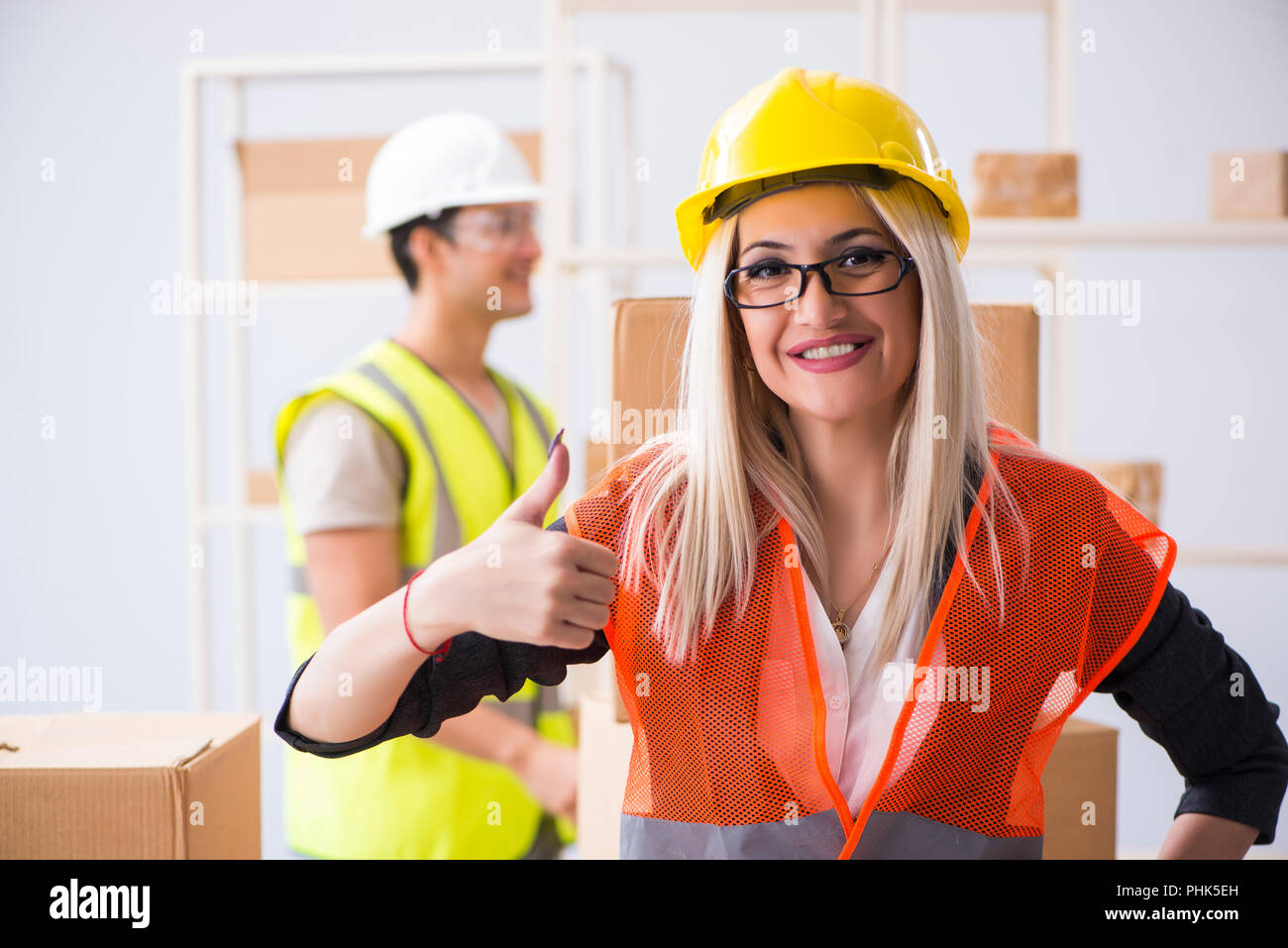 Delivery contractor delivering boxes to office Stock Photo - Alamy