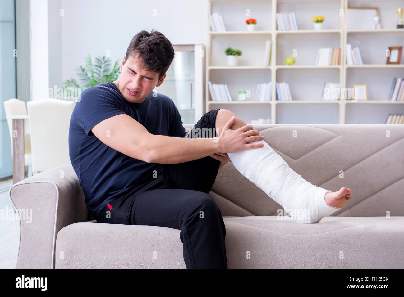 Man with broken leg recovering at home Stock Photo - Alamy