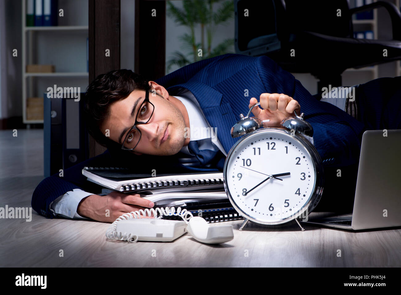 Working long hours in office hi-res stock photography and images - Alamy