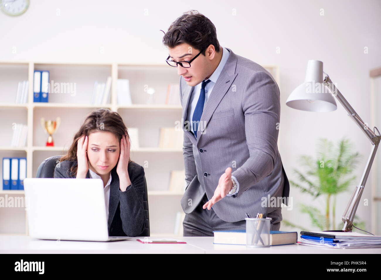 Angry boss unhappy with female employee performance Stock Photo - Alamy