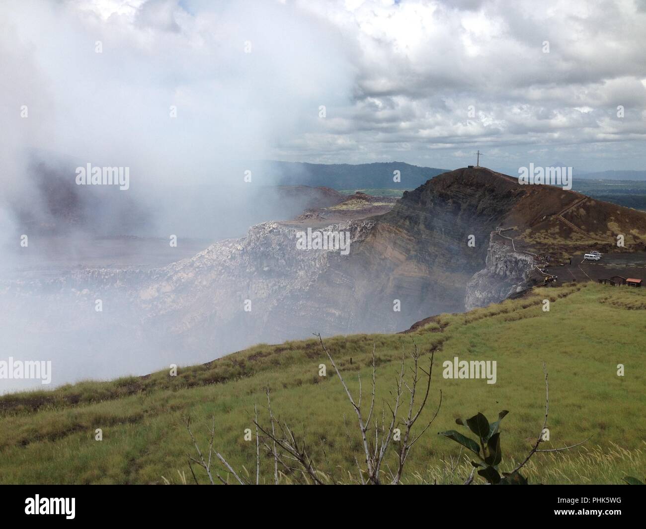 Smoking Masaya volcano crater and cross at Masaya National Park ...