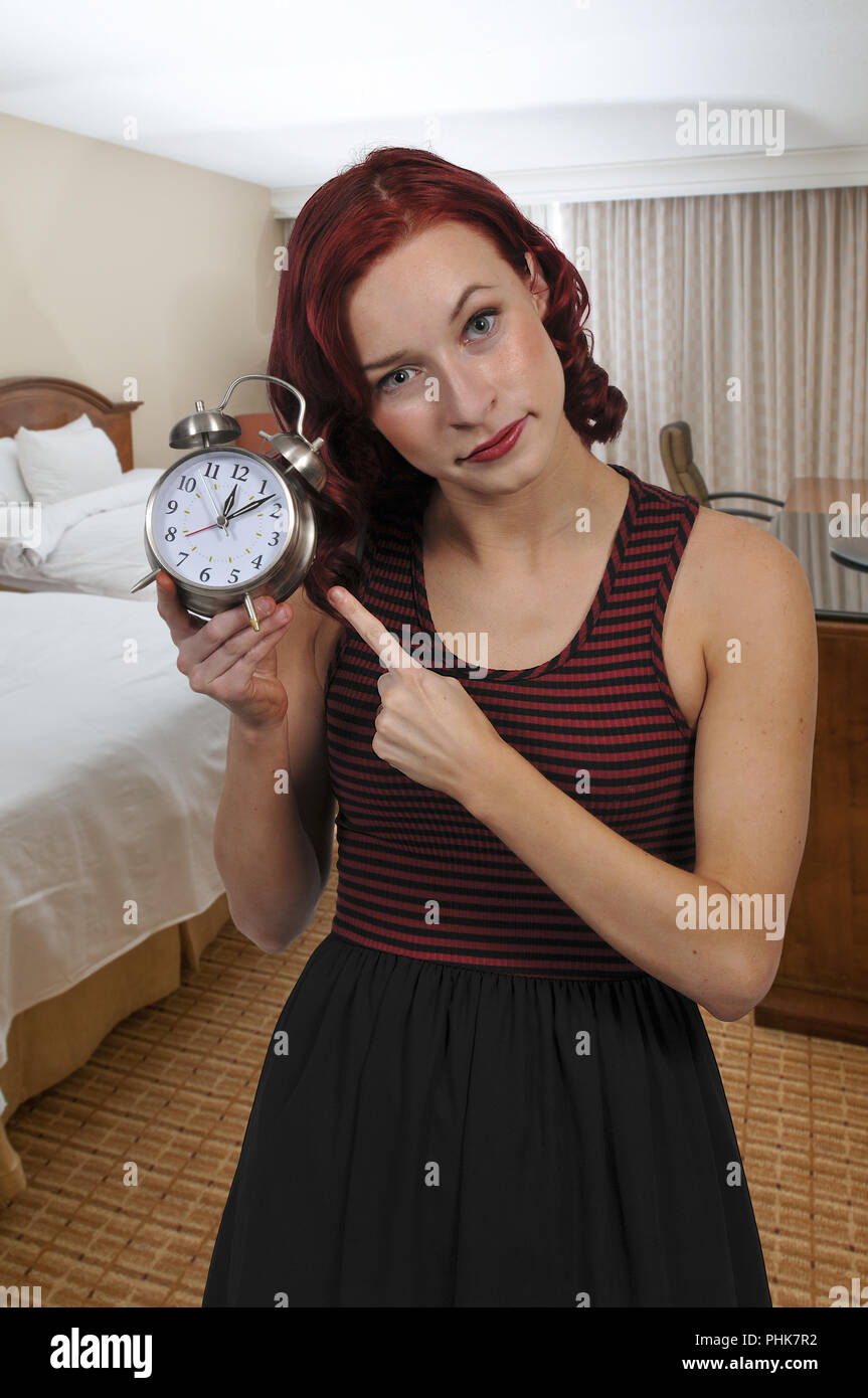 Angry woman with alarm clock Stock Photo - Alamy