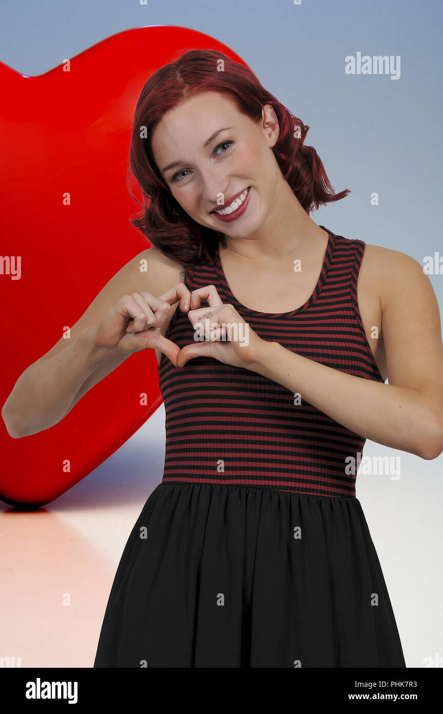 Girl making love heart sign hi-res stock photography and images - Alamy