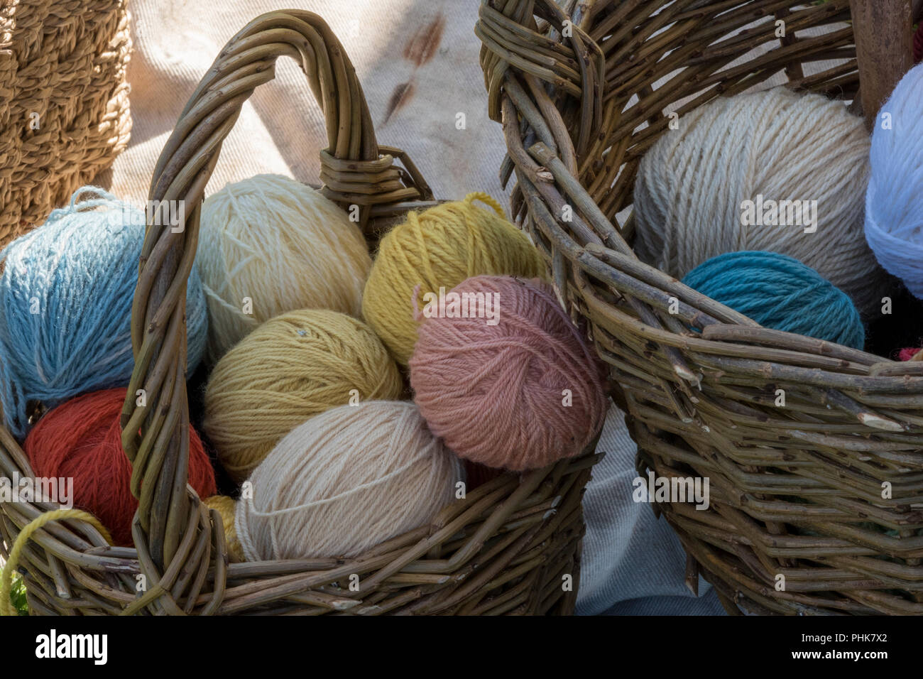 coloured wool in balls and rolls in some wicker baskets Stock Photo - Alamy