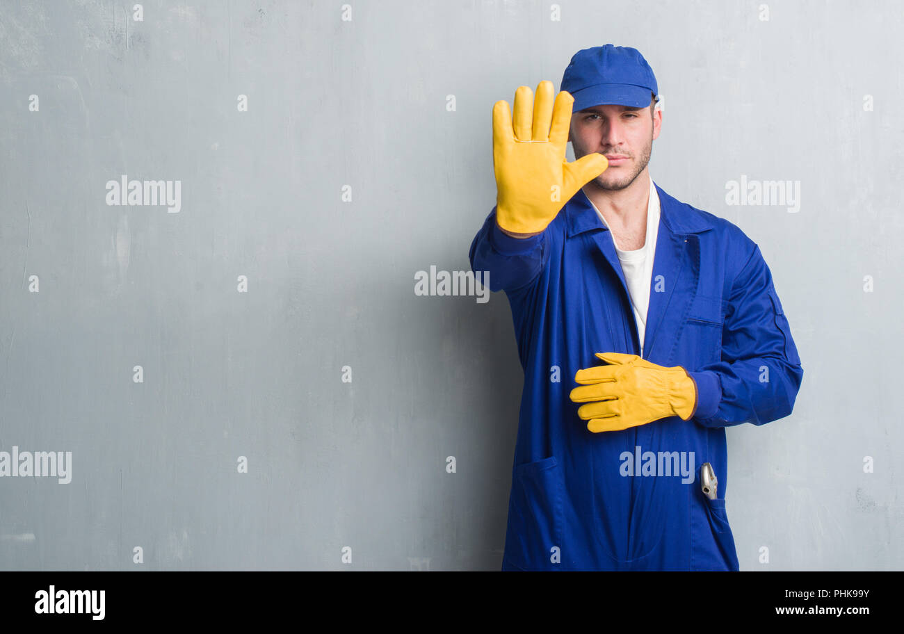 Workman holding stop sign hi-res stock photography and images - Alamy