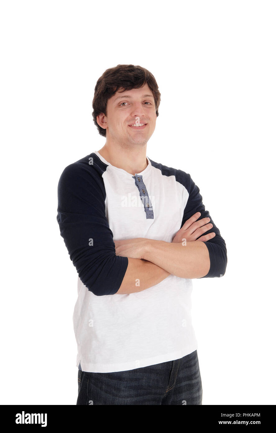 Relaxed young man standing with his arms crossed Stock Photo - Alamy
