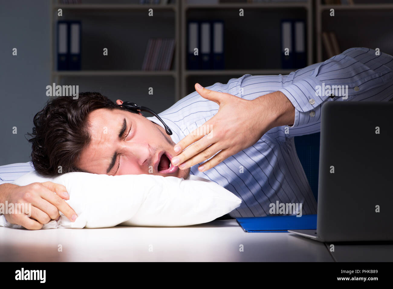 Tired and exhausted helpdesk operator during night shift Stock Photo ...